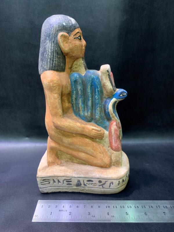 In a perfect scene the statue of Senenmut with the cobra wearing the ...