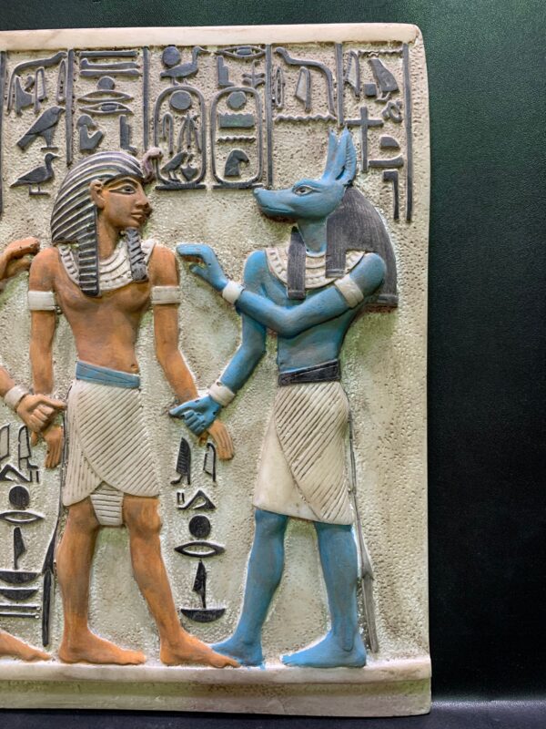 Replica wall relief of one of RAMSES II tomb – God Anubis and Horus wearing the crown giving ...