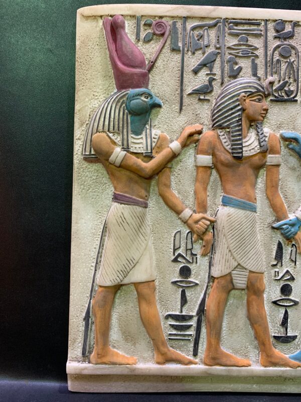 Replica wall relief of one of RAMSES II tomb – God Anubis and Horus wearing the crown giving ...